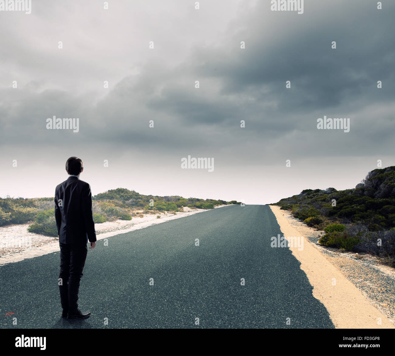 Back view of businessman standing on road and looking far away Stock ...