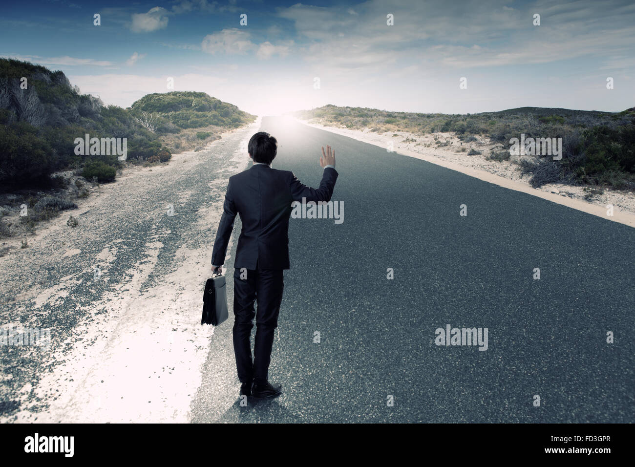 Back view of businessman standing on road and looking far away Stock ...