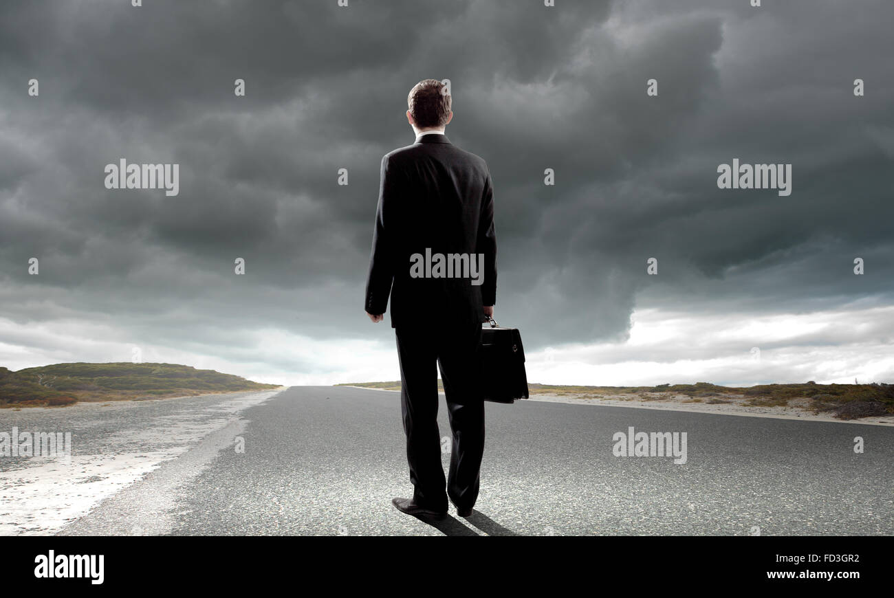 Back view of businessman standing on road and looking far away Stock ...