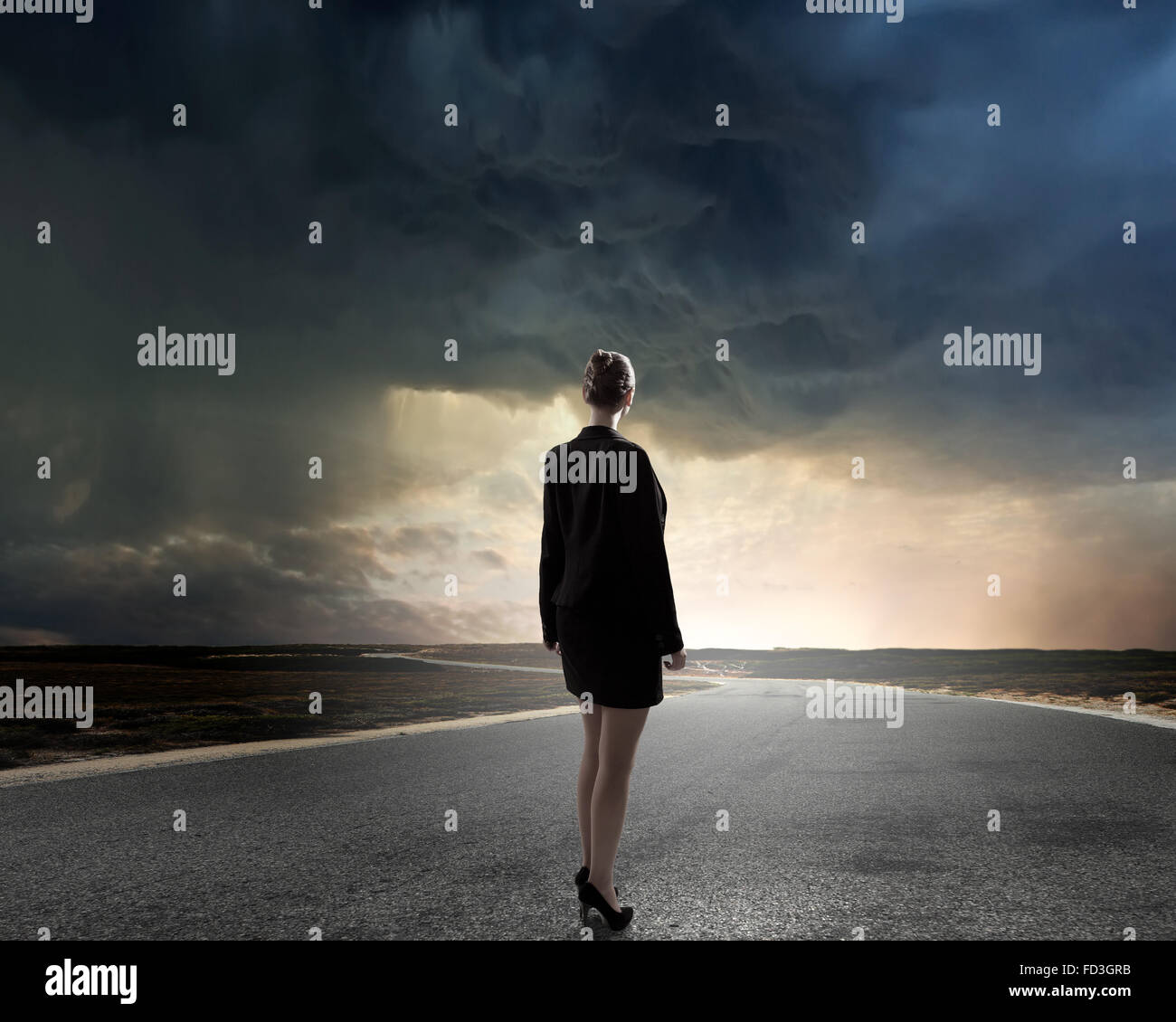 Back view of businesswoman standing on road and looking far away Stock ...
