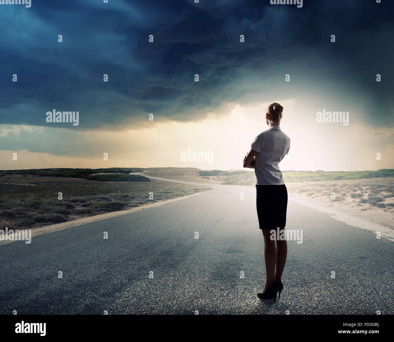 Back view of businesswoman standing on road and looking far away Stock ...