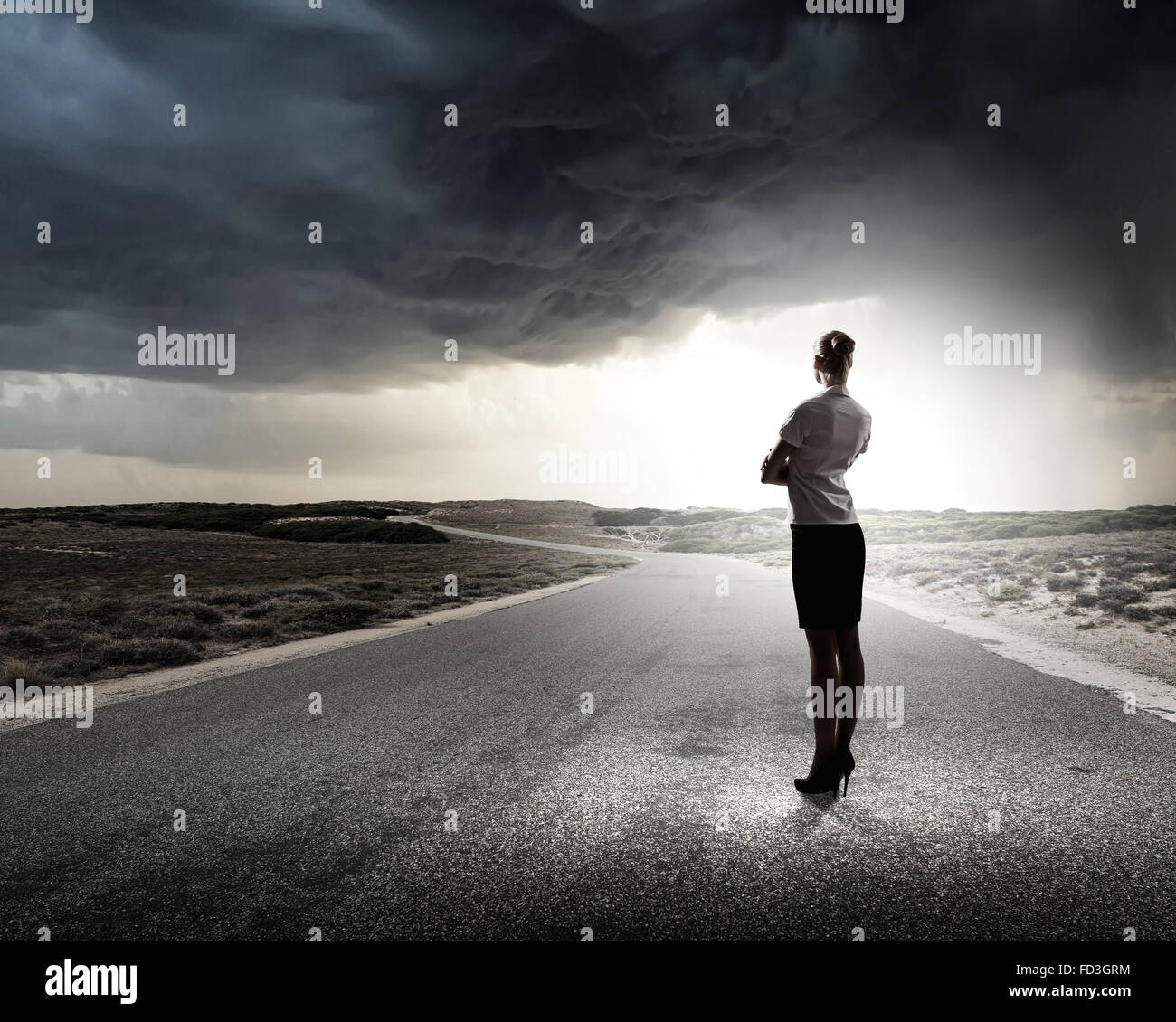 Back view of businesswoman standing on road and looking far away Stock ...