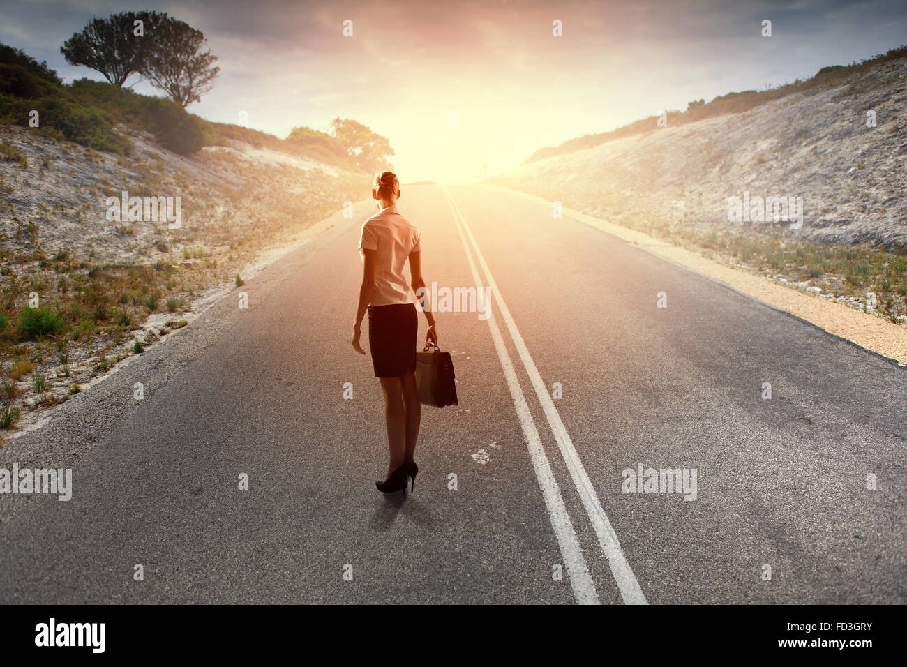 Back view of businesswoman standing on road and looking far away Stock ...