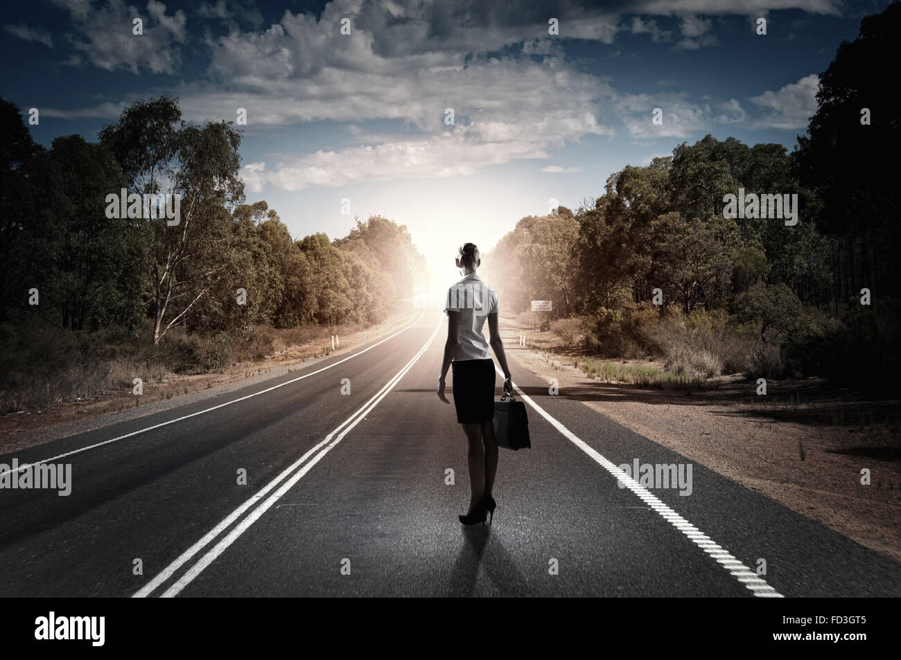 Back view of businesswoman standing on road and looking far away Stock ...