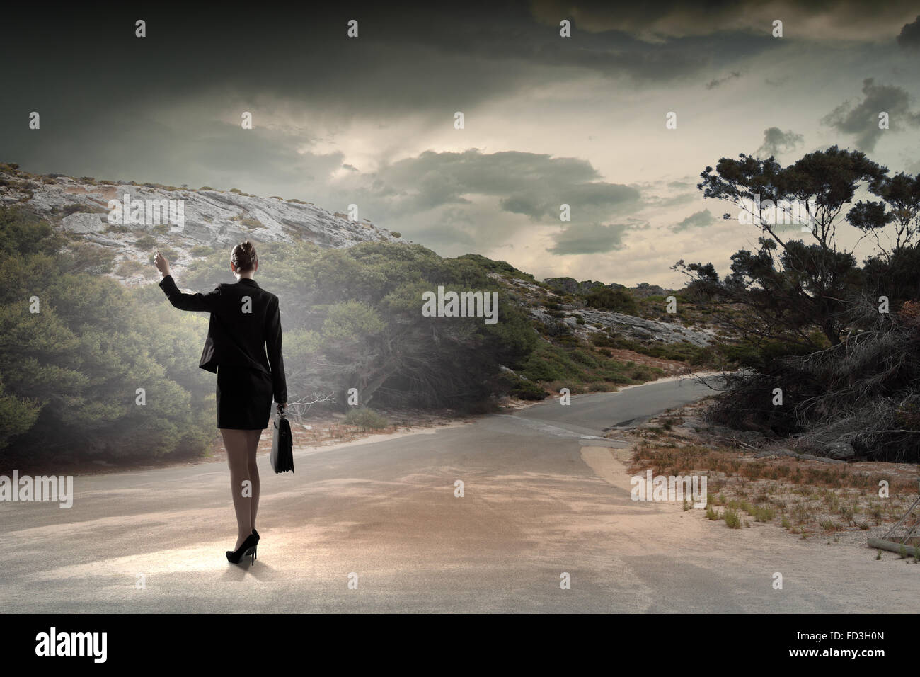 Back view of businesswoman standing on road and looking far away Stock ...