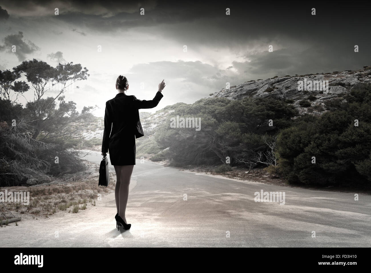 Back view of businesswoman standing on road and looking far away Stock ...