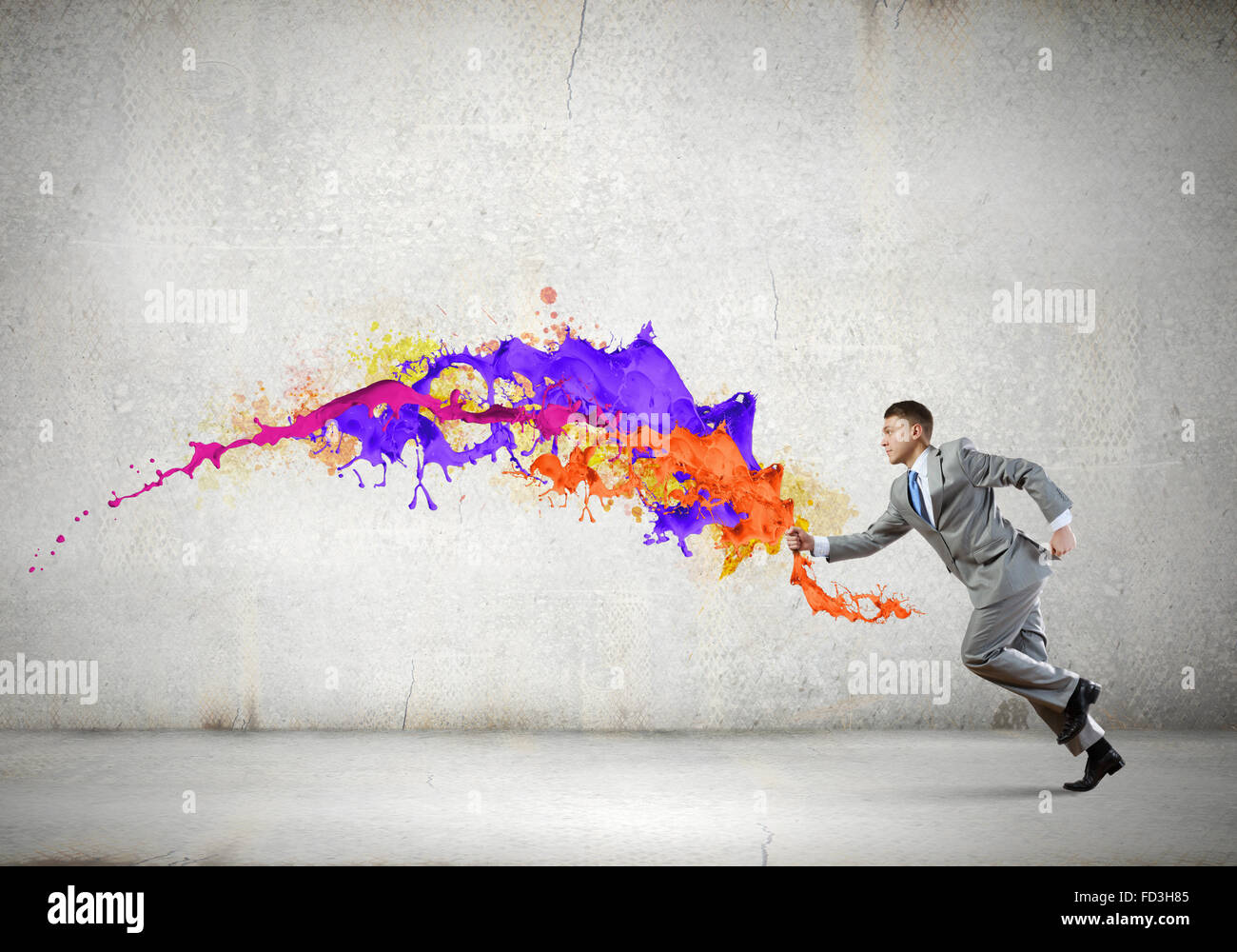 Cheerful young businessman running in a hurry Stock Photo - Alamy