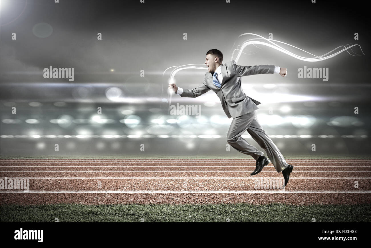 Cheerful young businessman running in a hurry Stock Photo - Alamy