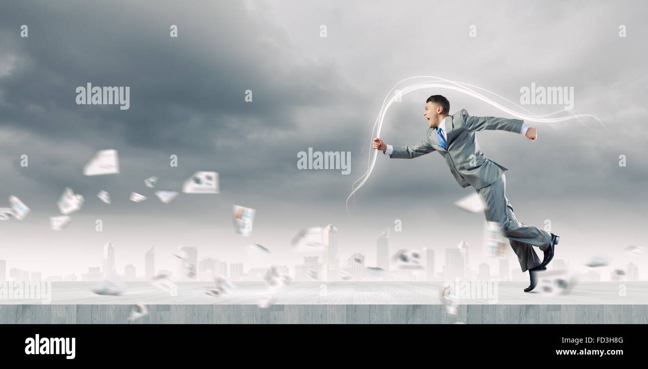 Cheerful young businessman running in a hurry Stock Photo - Alamy