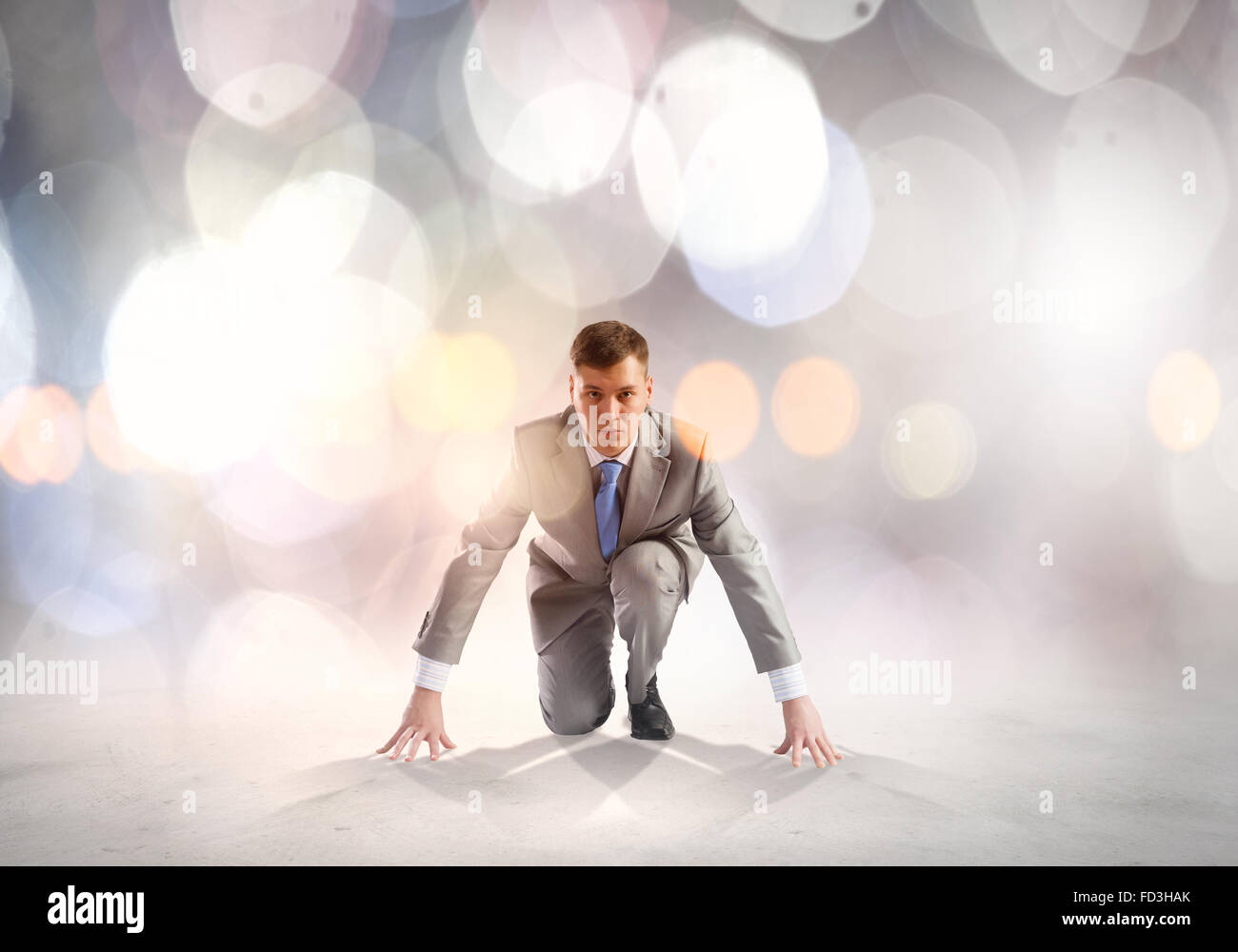 Young determined businessman standing in start position Stock Photo - Alamy