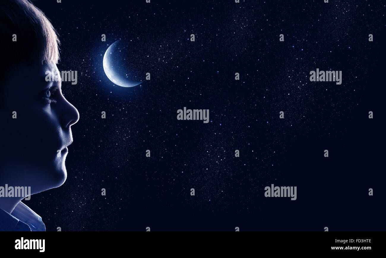 Cute boy of school age against night background Stock Photo - Alamy