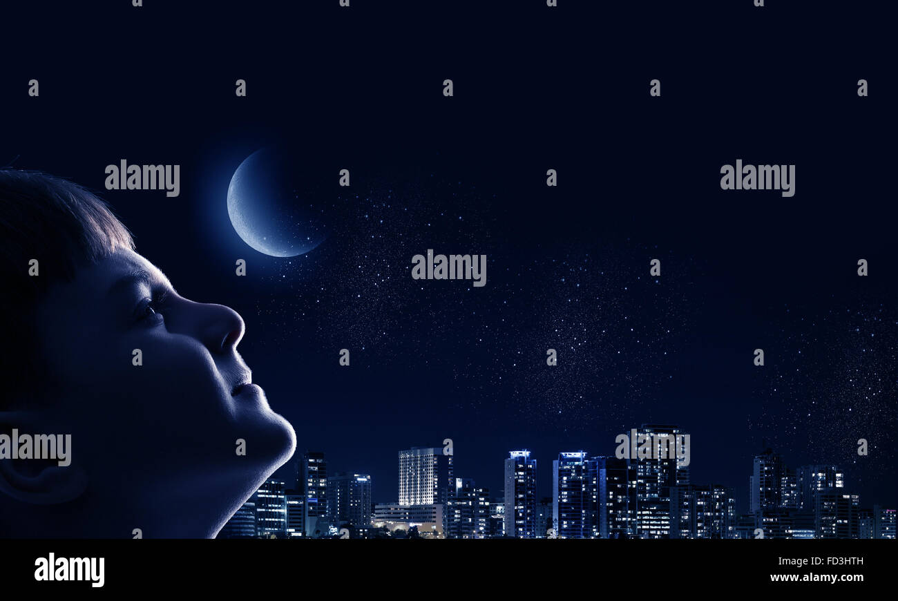 Cute boy of school age against night background Stock Photo - Alamy