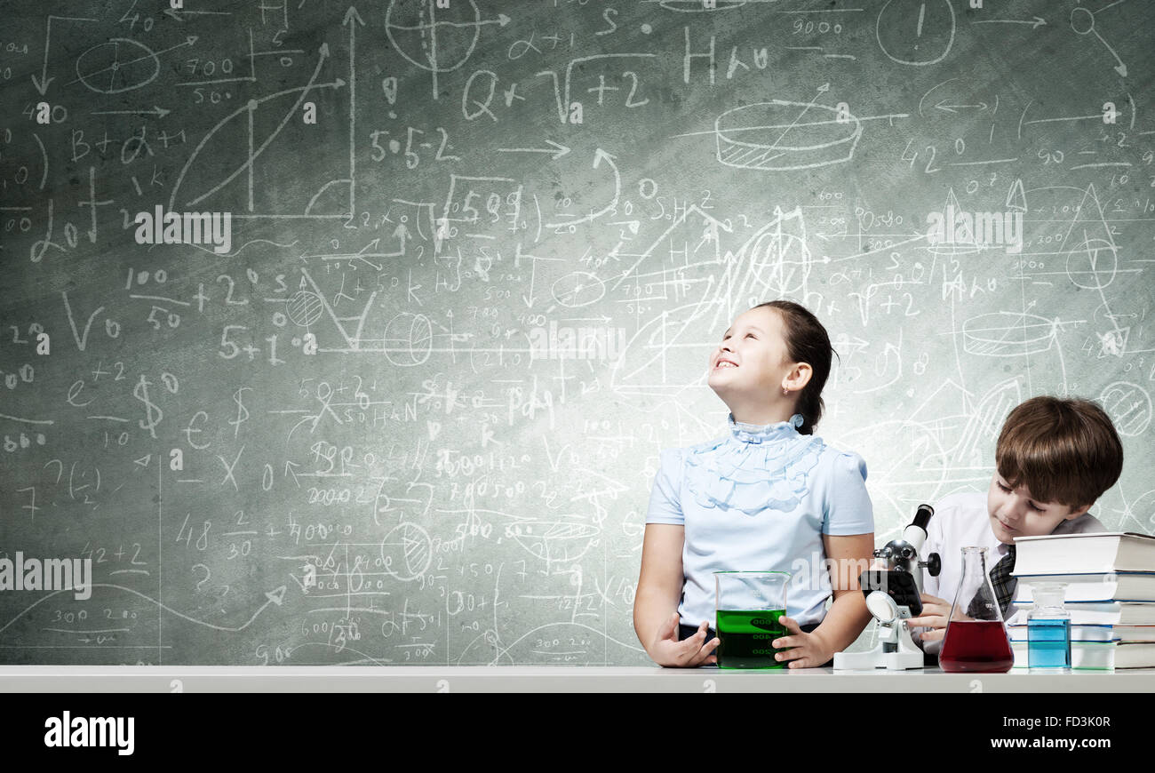 Cute girl and boy at chemistry lesson making tests Stock Photo - Alamy