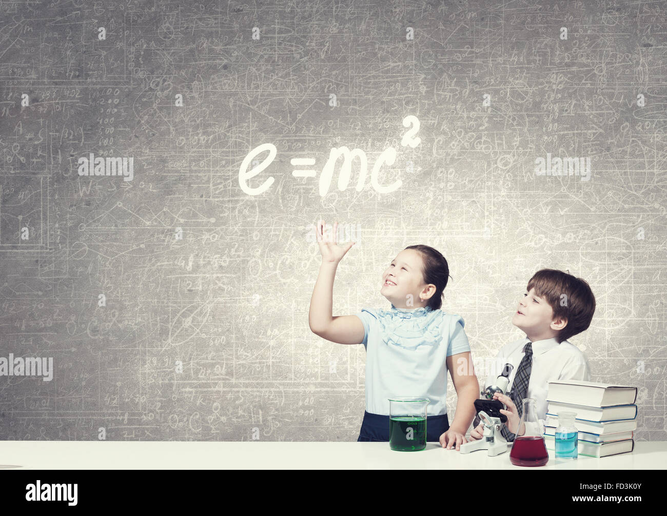 Cute girl and boy at chemistry lesson making tests Stock Photo - Alamy