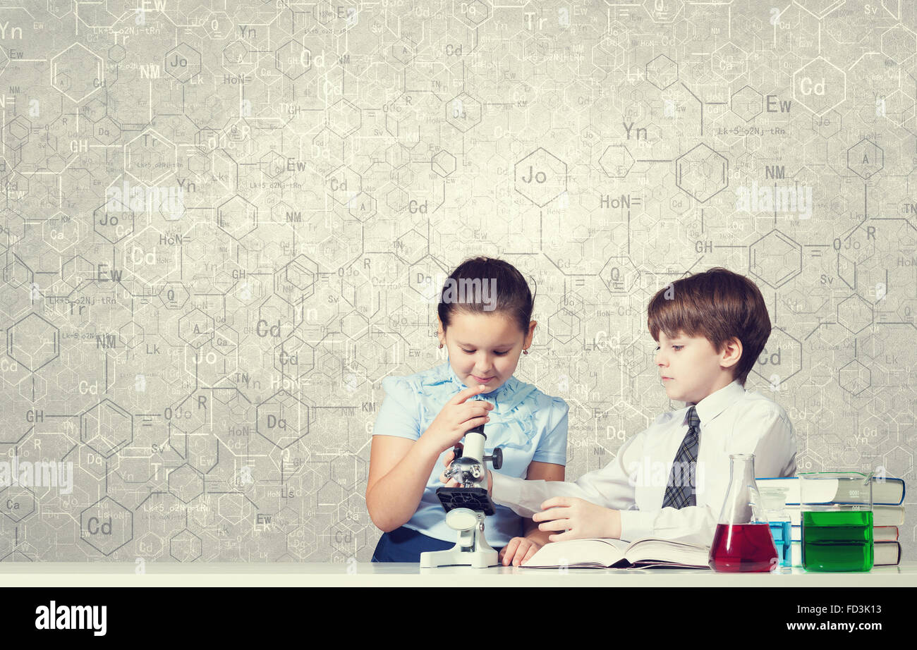 Cute girl and boy at chemistry lesson making tests Stock Photo - Alamy