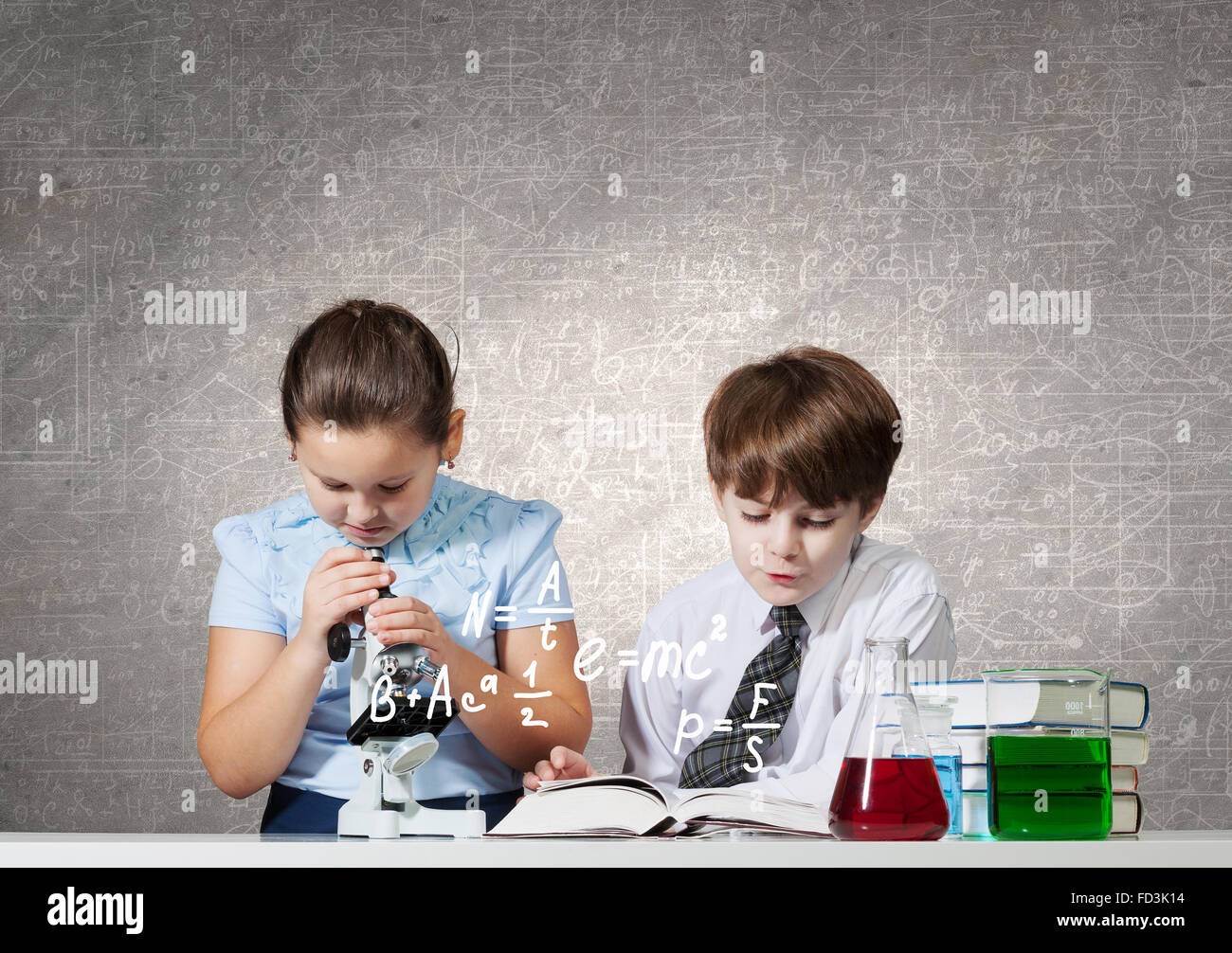 Cute girl and boy at chemistry lesson making tests Stock Photo - Alamy
