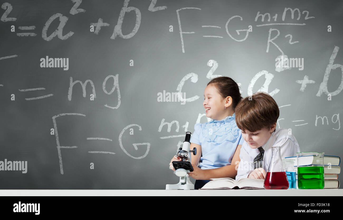 Cute girl and boy at chemistry lesson making tests Stock Photo - Alamy