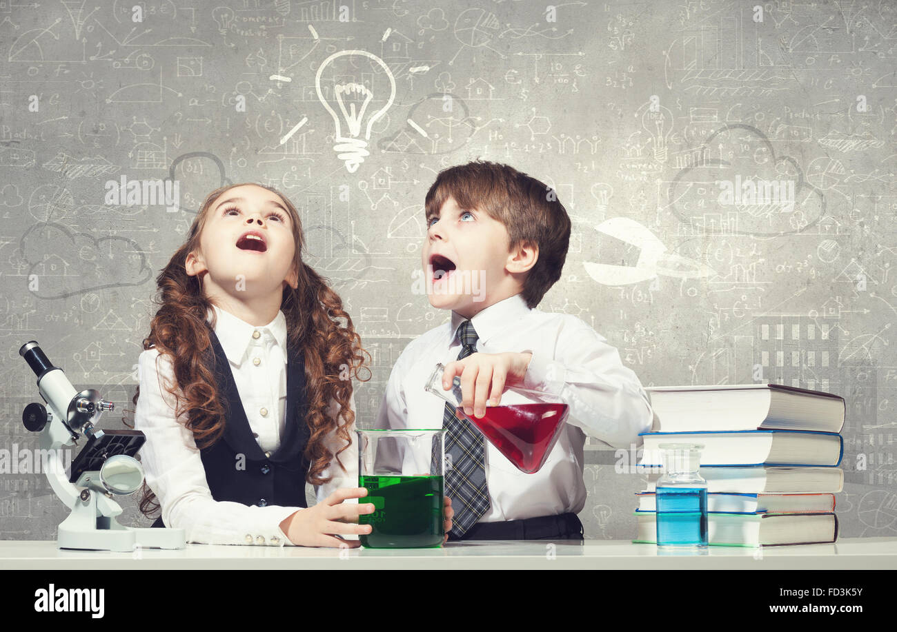 Cute girl and boy at chemistry lesson making tests Stock Photo - Alamy