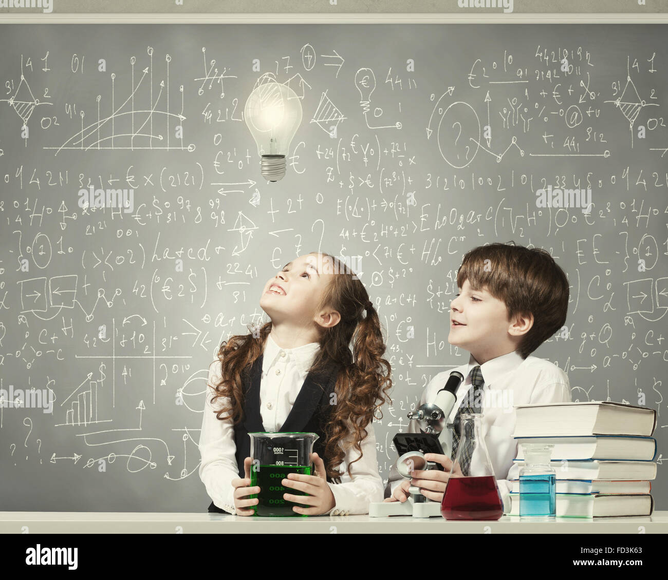 Cute girl and boy at chemistry lesson making tests Stock Photo - Alamy