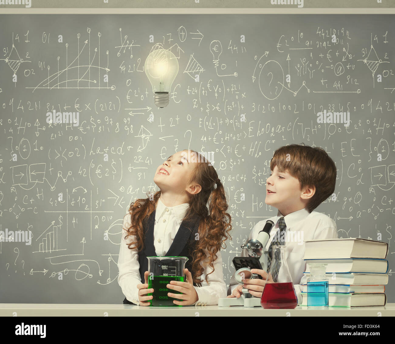 Cute girl and boy at chemistry lesson making tests Stock Photo - Alamy