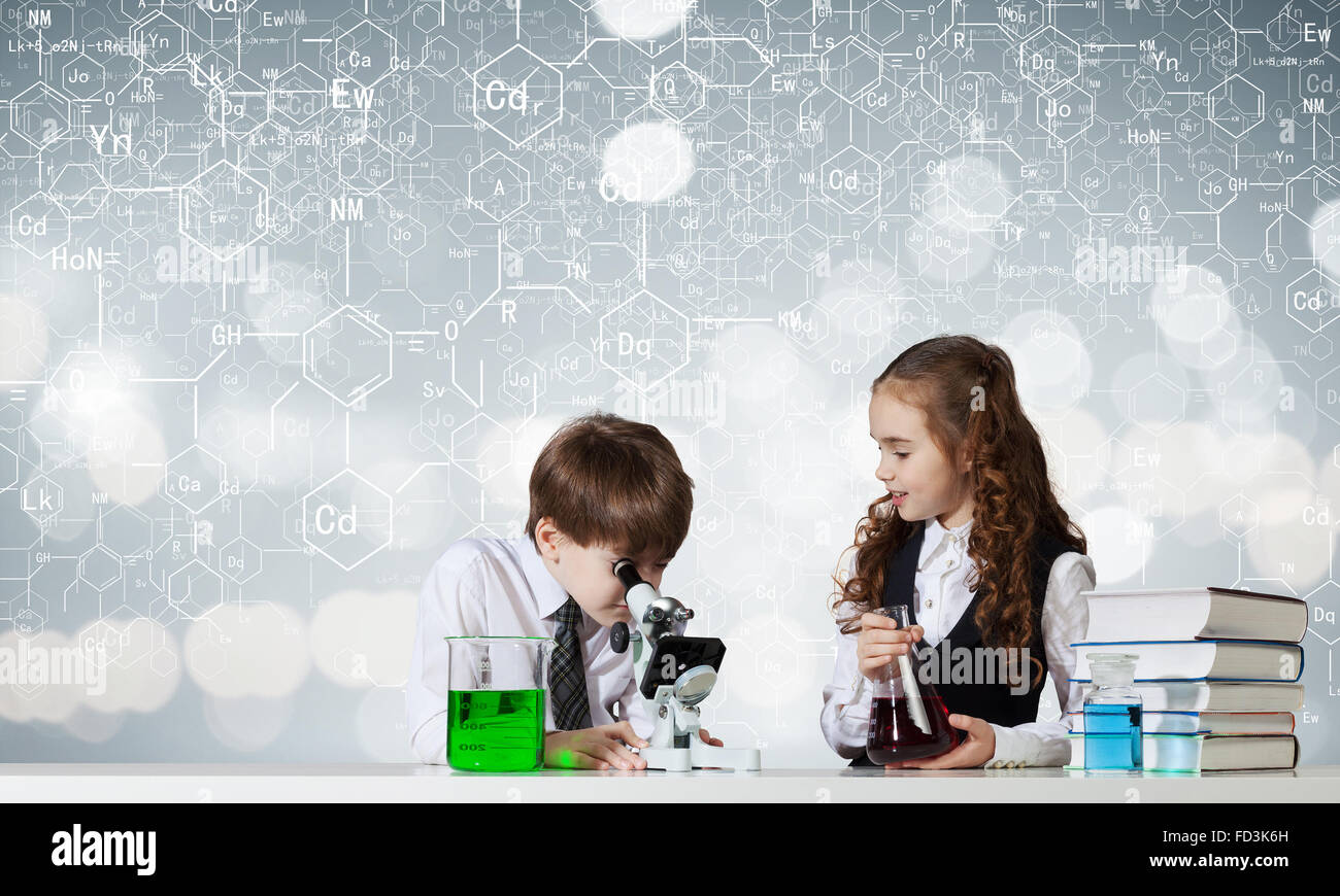 Cute girl and boy at chemistry lesson making tests Stock Photo - Alamy