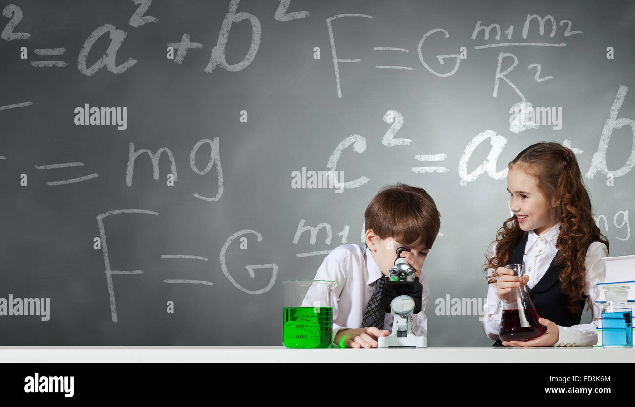 Cute girl and boy at chemistry lesson making tests Stock Photo - Alamy