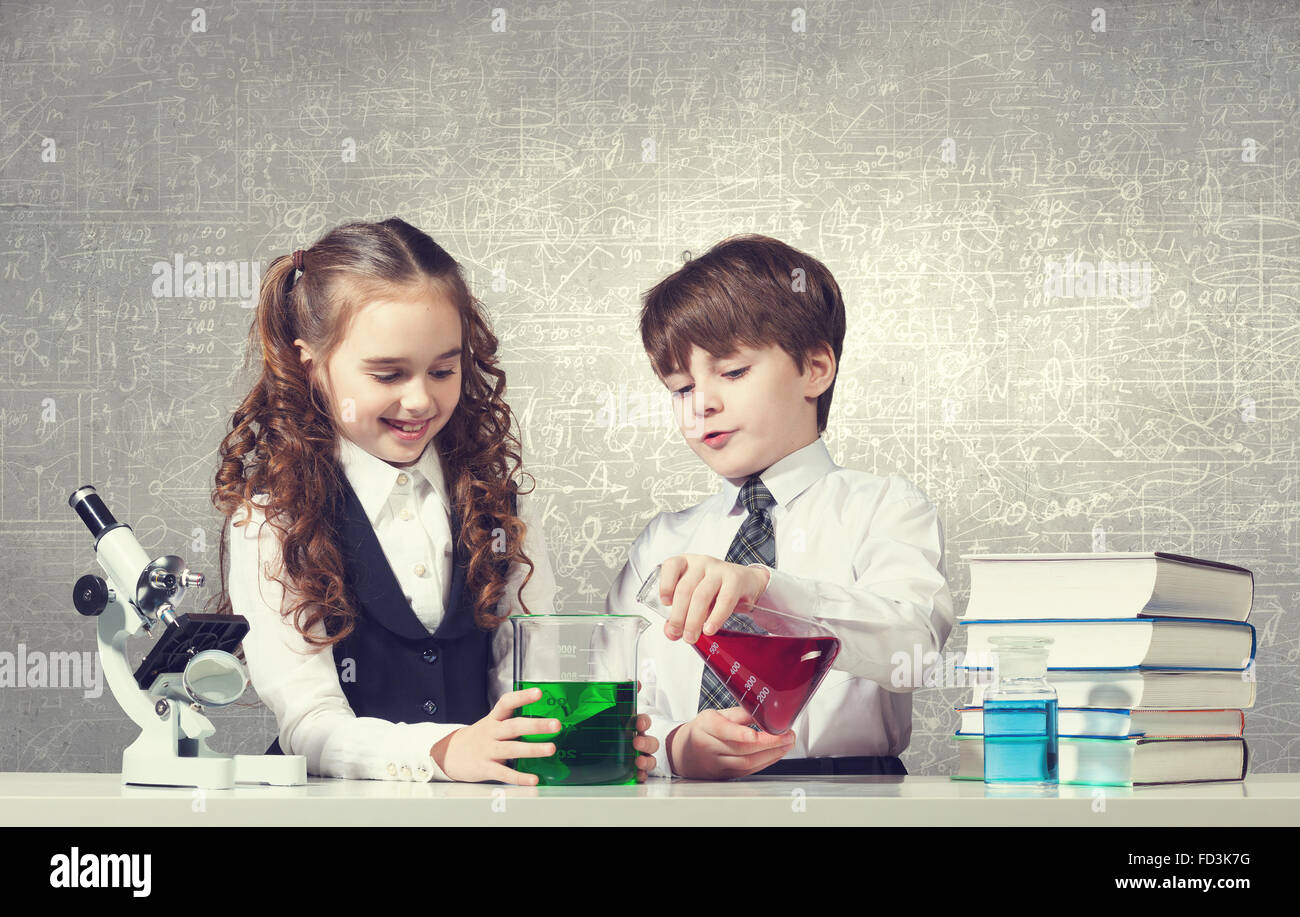 Cute girl and boy at chemistry lesson making tests Stock Photo - Alamy