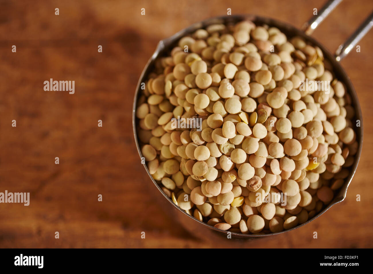 A cup of dried brown lentils Stock Photo - Alamy