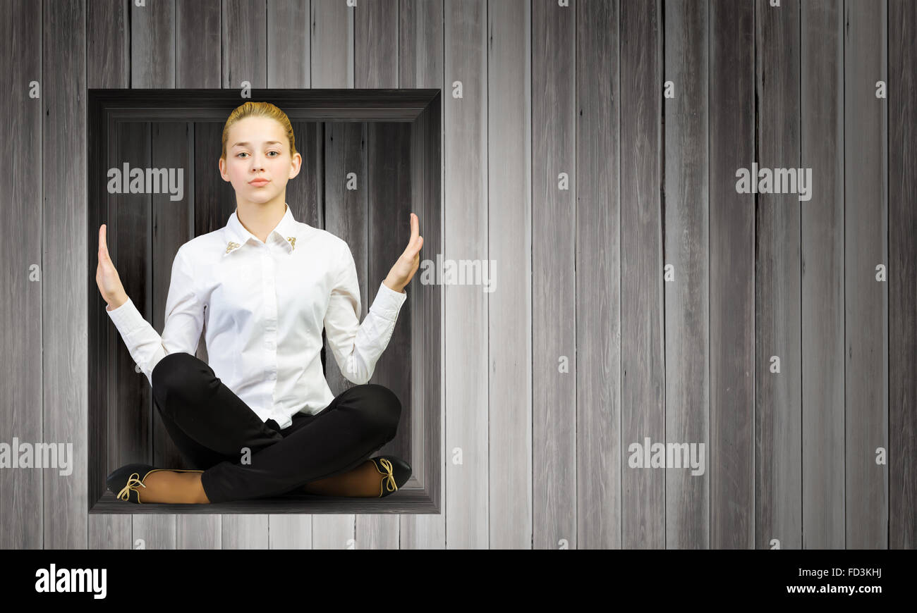 Young woman trapped in wooden cube in wall Stock Photo - Alamy