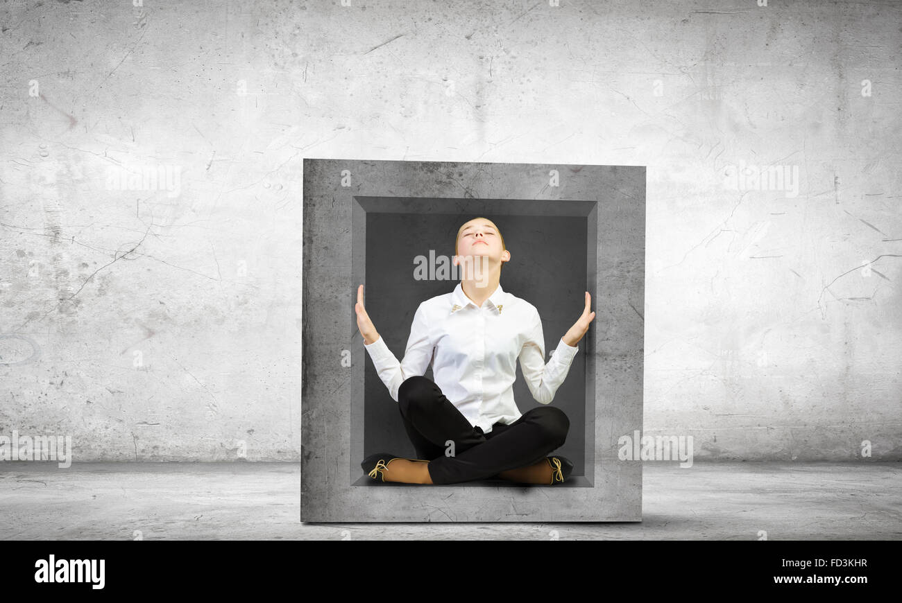 Young woman trapped in stone cube in wall Stock Photo - Alamy