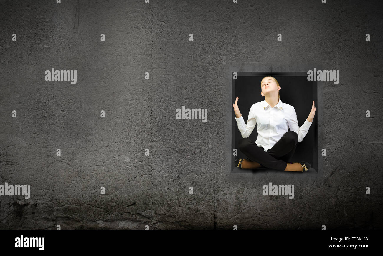 Young woman trapped in stone cube in wall Stock Photo - Alamy