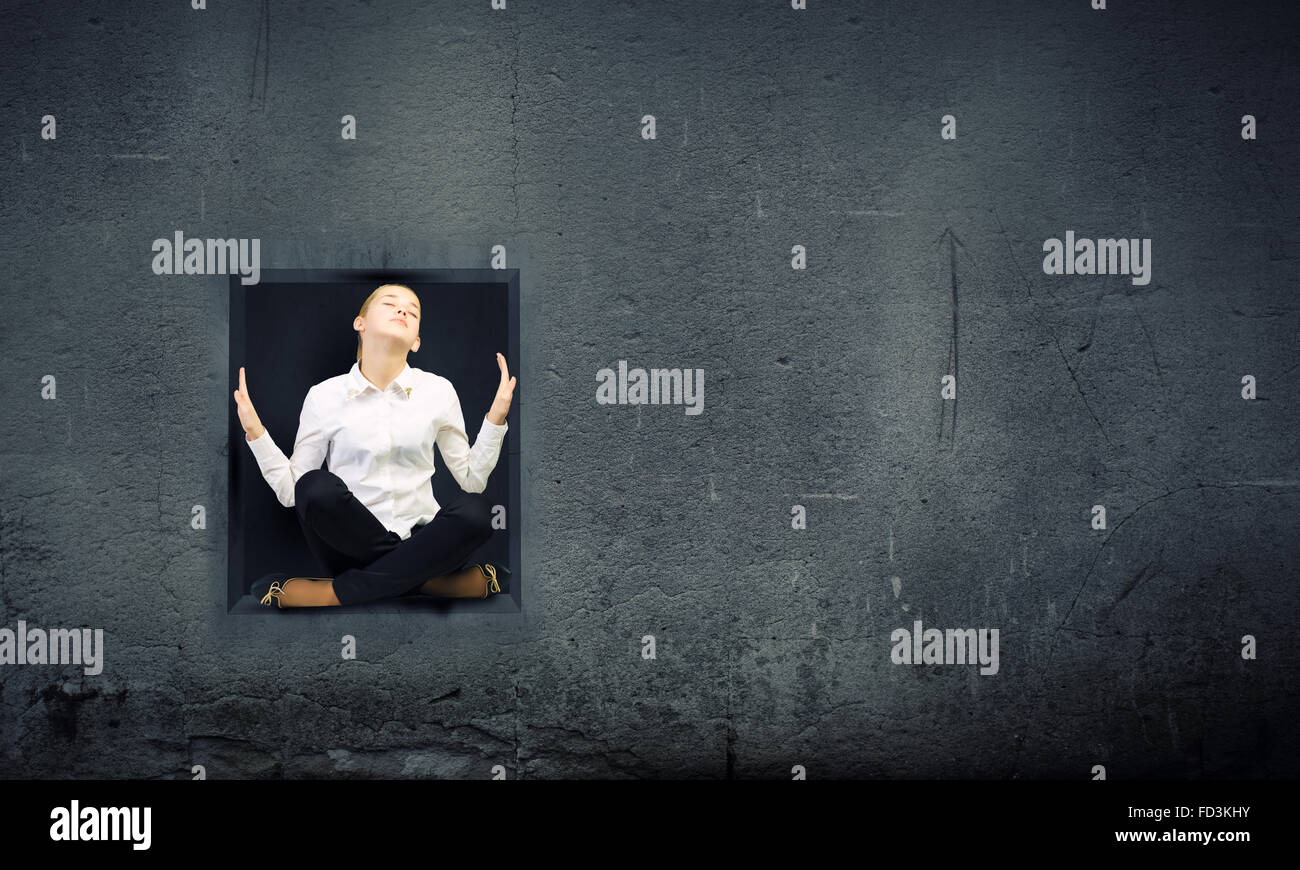 Young woman trapped in stone cube in wall Stock Photo - Alamy