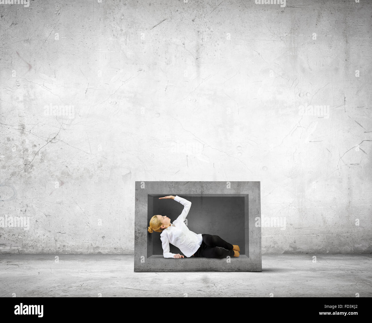 Young woman trapped in stone cube in wall Stock Photo - Alamy