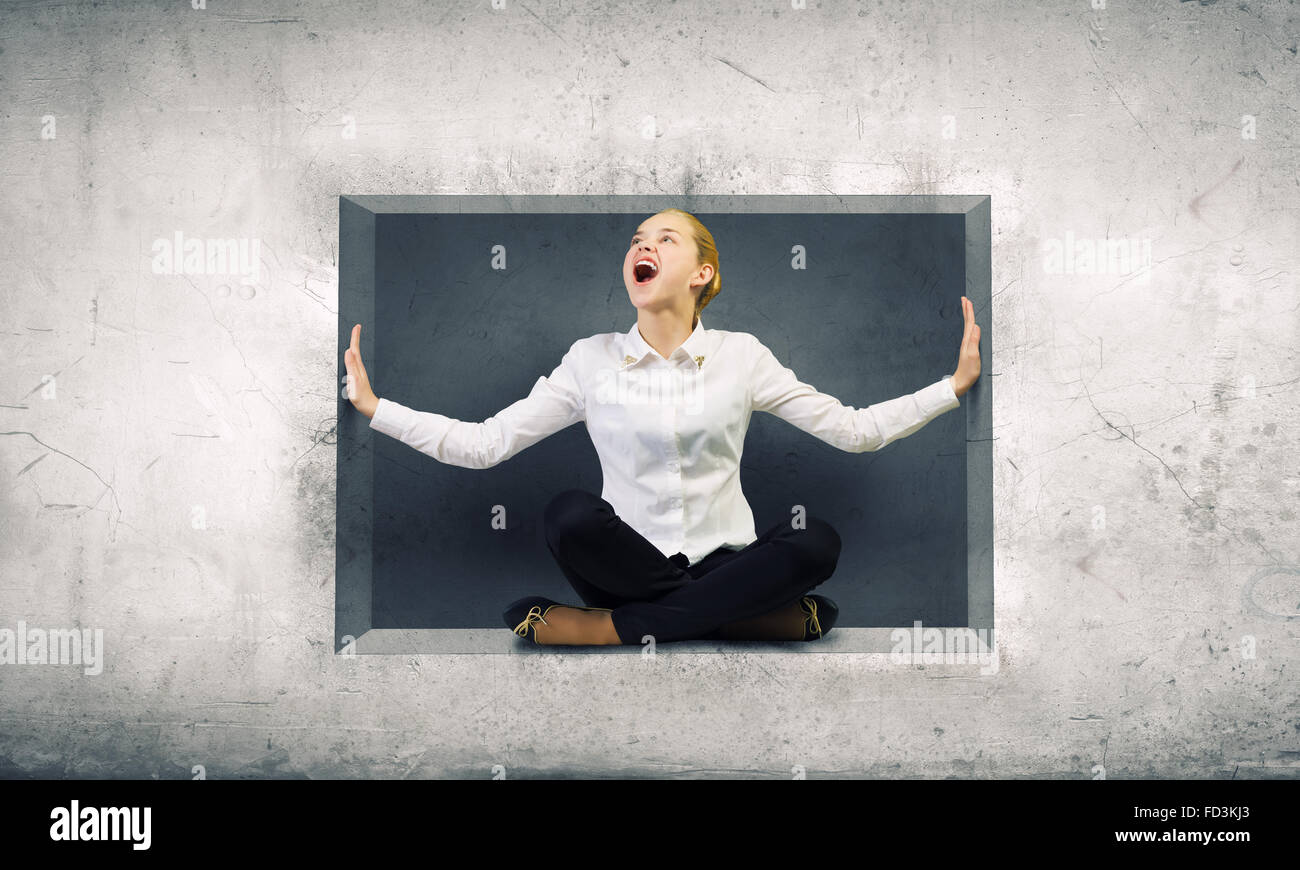 Young woman trapped in stone cube in wall Stock Photo - Alamy