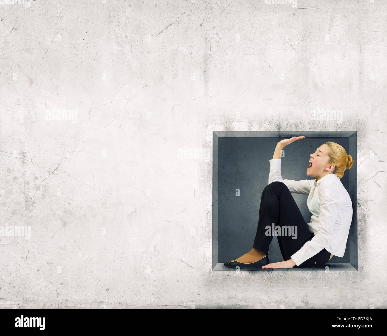 Young woman trapped in stone cube in wall Stock Photo - Alamy