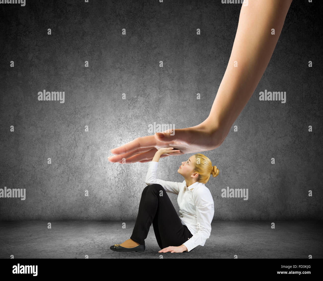 Young woman sitting on floor and pressed by huge hand Stock Photo - Alamy
