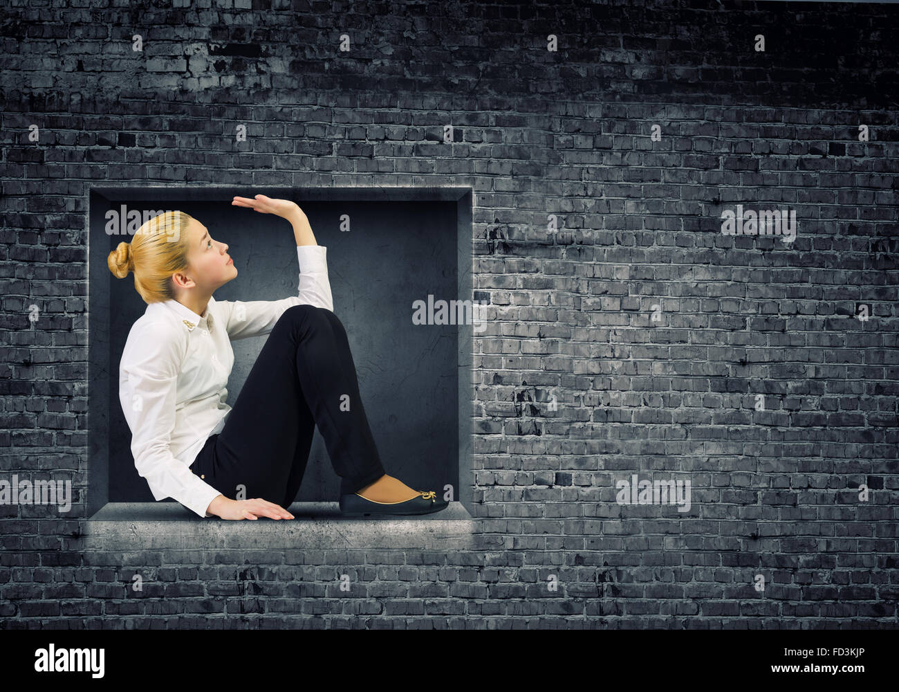 Young woman trapped in stone cube in wall Stock Photo - Alamy