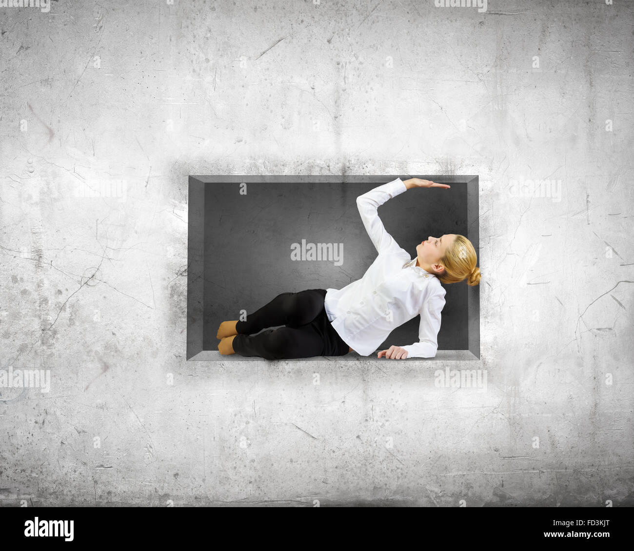 Young woman trapped in stone cube in wall Stock Photo - Alamy