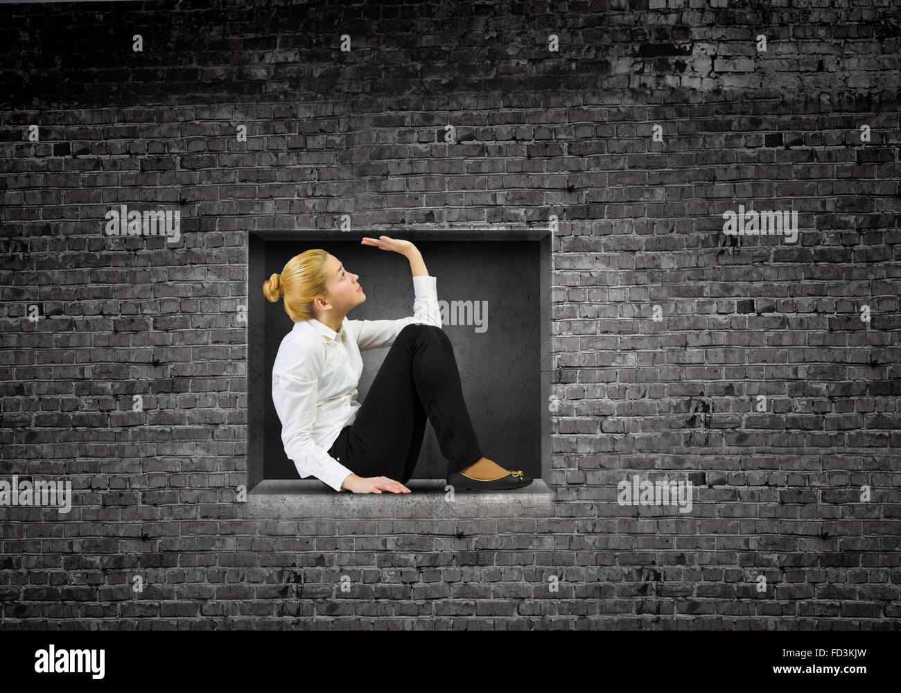 Young woman trapped in stone cube in wall Stock Photo - Alamy