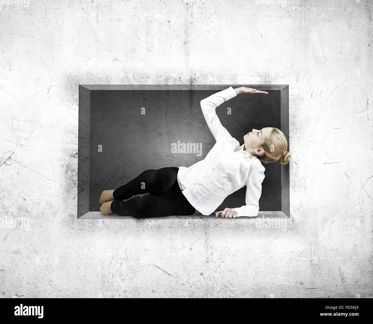 Young woman trapped in stone cube in wall Stock Photo - Alamy