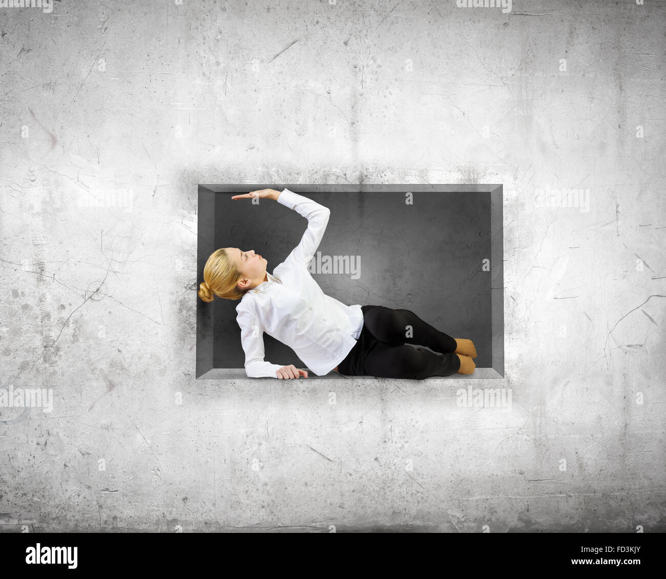 Young woman trapped in stone cube in wall Stock Photo - Alamy