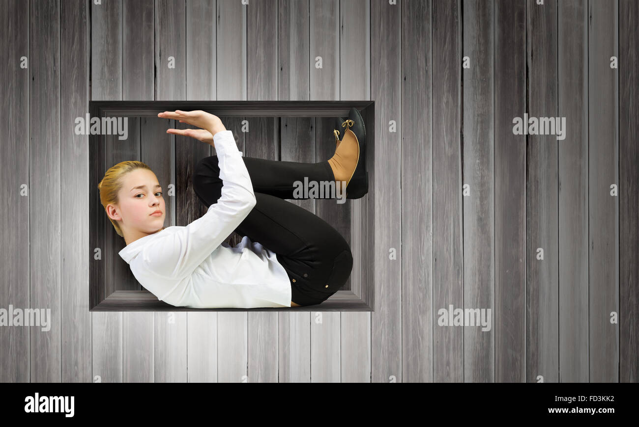 Young woman trapped in wooden cube in wall Stock Photo - Alamy