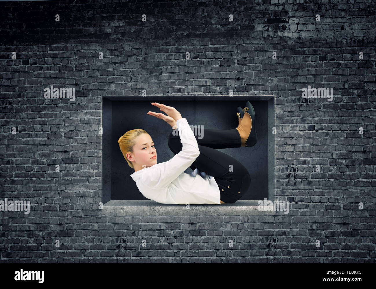 Young woman trapped in stone cube in wall Stock Photo - Alamy