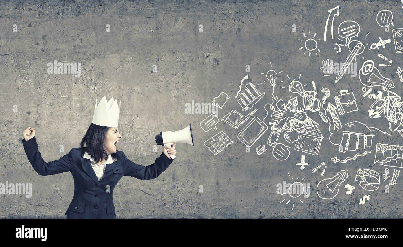 Young businesswoman in paper crown screaming in megaphone Stock Photo ...