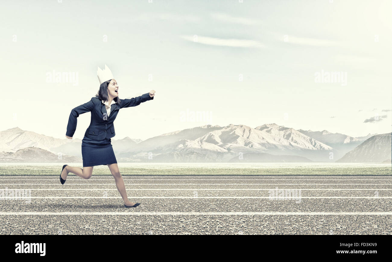 Young businesswoman in paper crown running in a hurry Stock Photo - Alamy