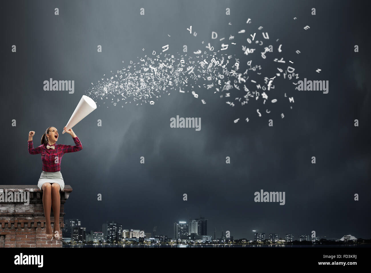 Young pretty woman screaming in paper trumpet Stock Photo - Alamy