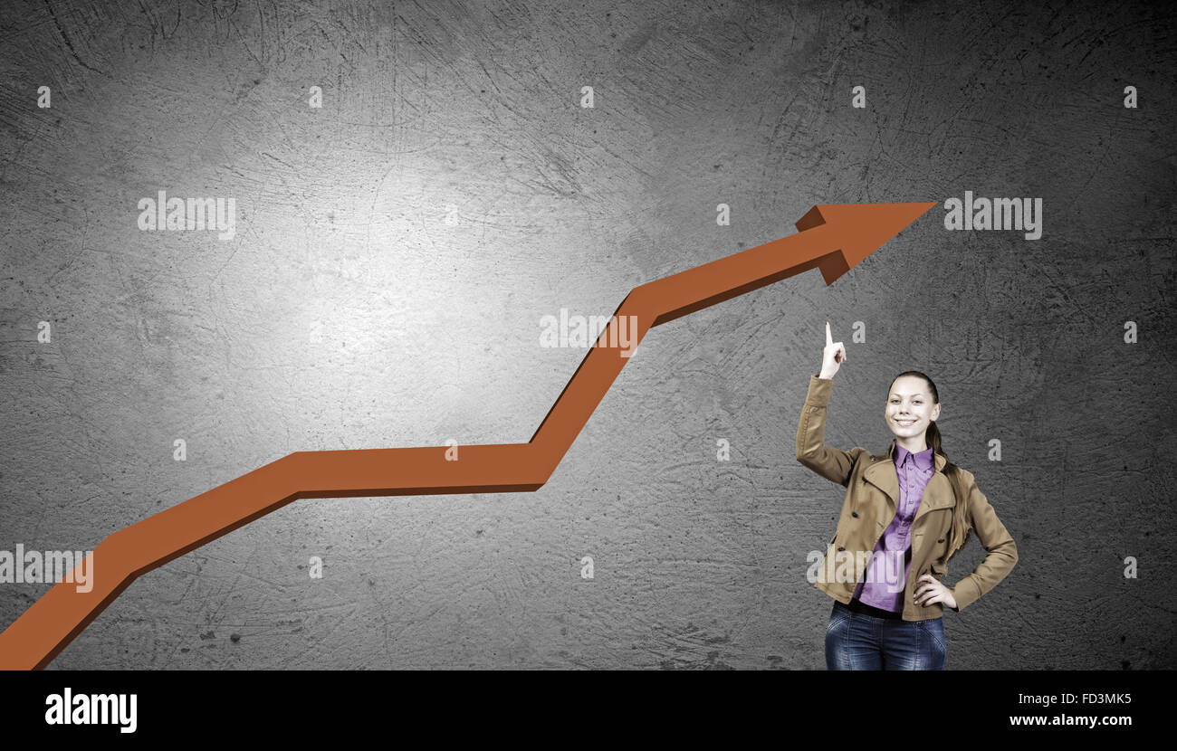 Young pretty woman pointing at increasing graph Stock Photo - Alamy