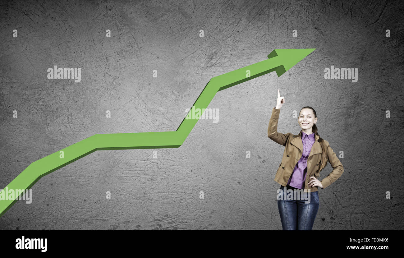 Young pretty woman pointing at increasing graph Stock Photo - Alamy