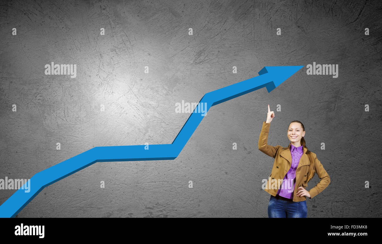 Young pretty woman pointing at increasing graph Stock Photo - Alamy