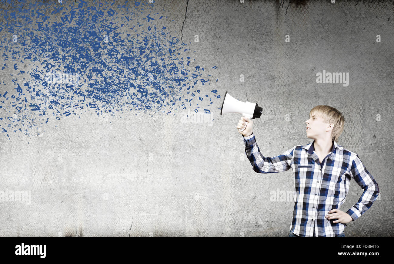 Young man in casual announcing something in megaphone Stock Photo - Alamy